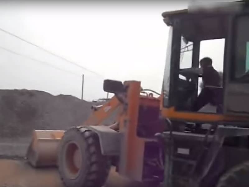 Small child operating wheel loader