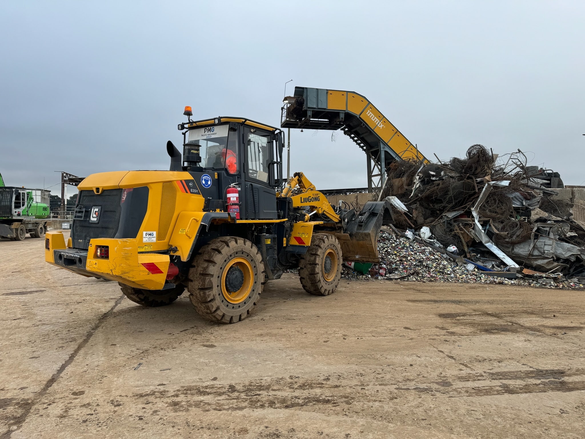 LiuGong wheel loader cleaning up in scrap metal recycling ...